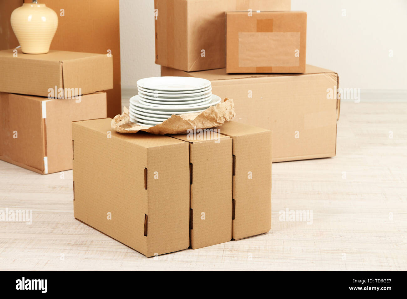 Moving boxes on the floor in empty room Stock Photo - Alamy