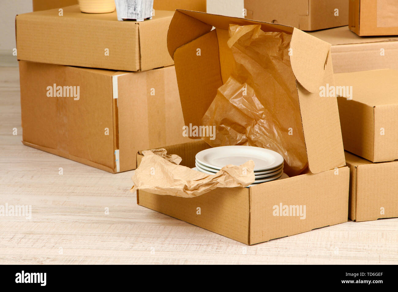 Moving boxes on the floor in empty room Stock Photo - Alamy