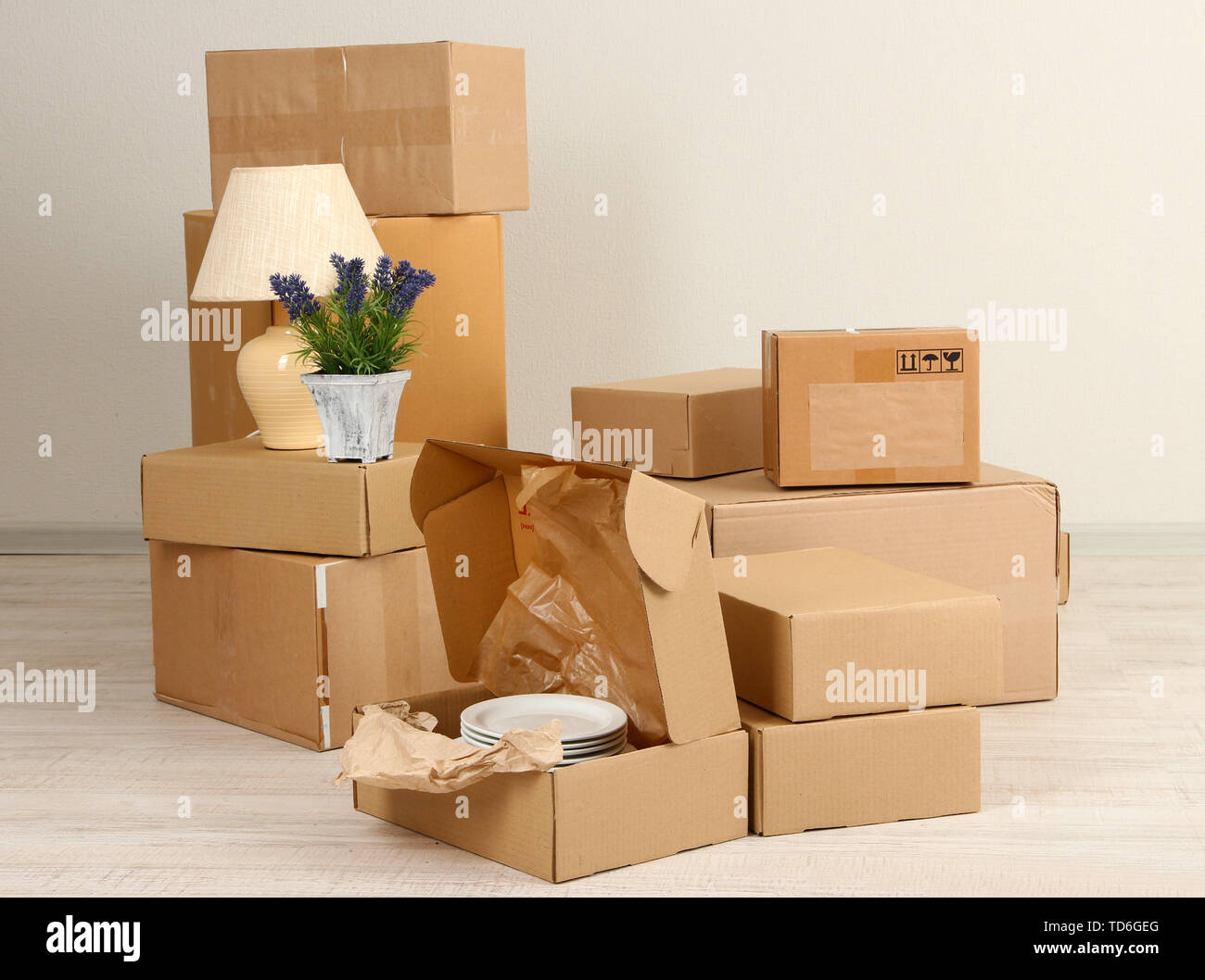 Moving boxes on the floor in empty room Stock Photo - Alamy