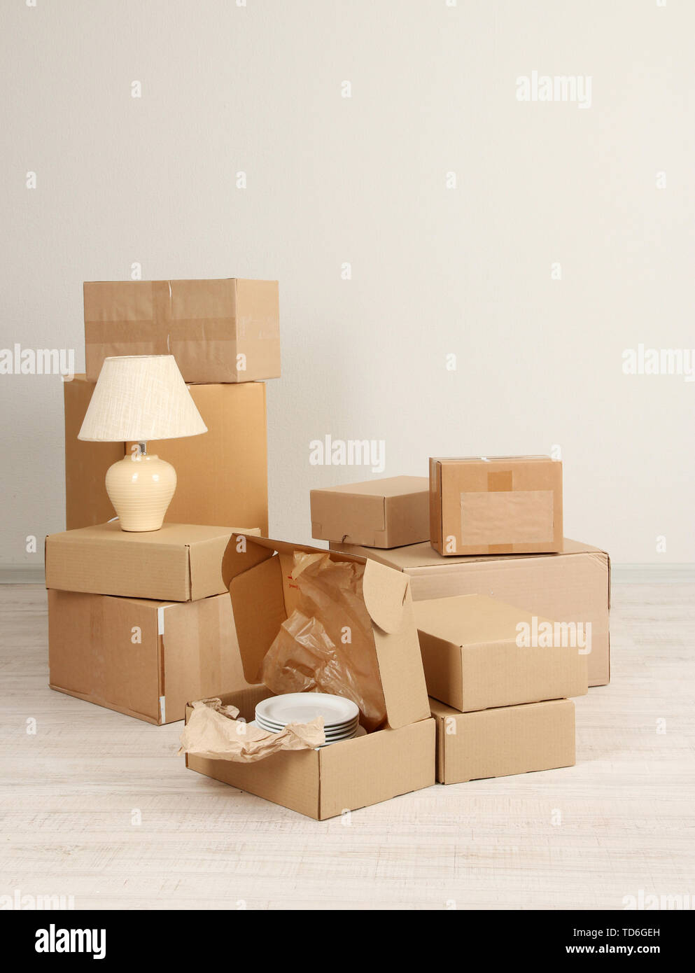 Moving boxes on the floor in empty room Stock Photo - Alamy