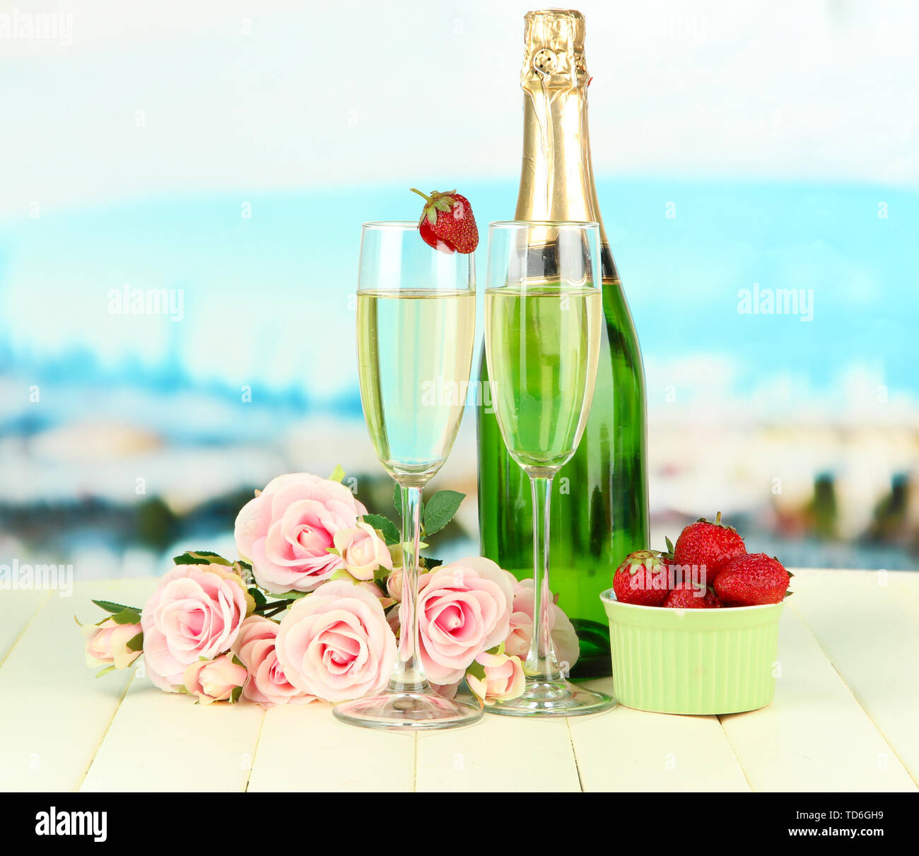 Romantic still life with champagne, strawberry and pink roses, on ...