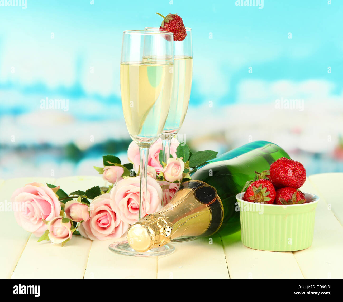 Romantic still life with champagne, strawberry and pink roses, on ...