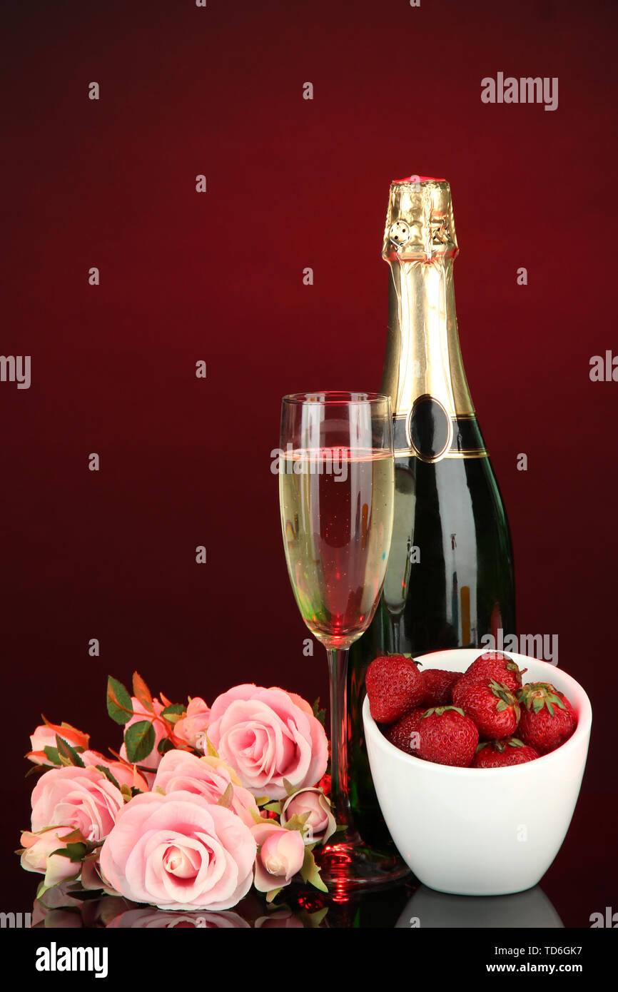Romantic still life with champagne, strawberry and pink roses, on dark ...