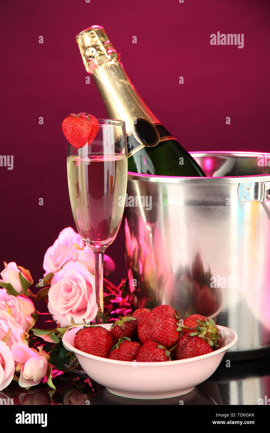 Romantic still life with champagne, strawberry and pink roses, on dark ...