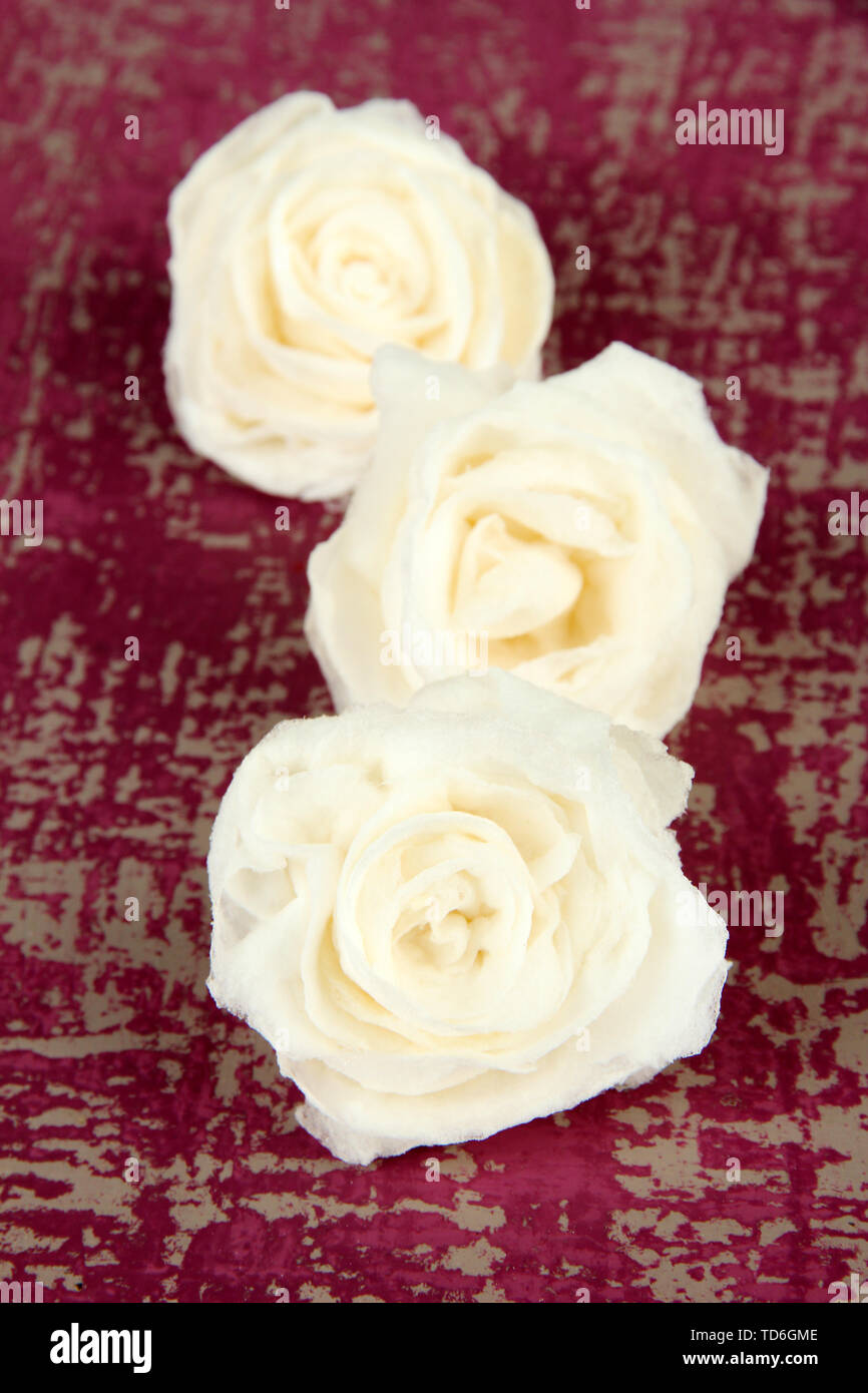 Sugar roses, on color background Stock Photo - Alamy