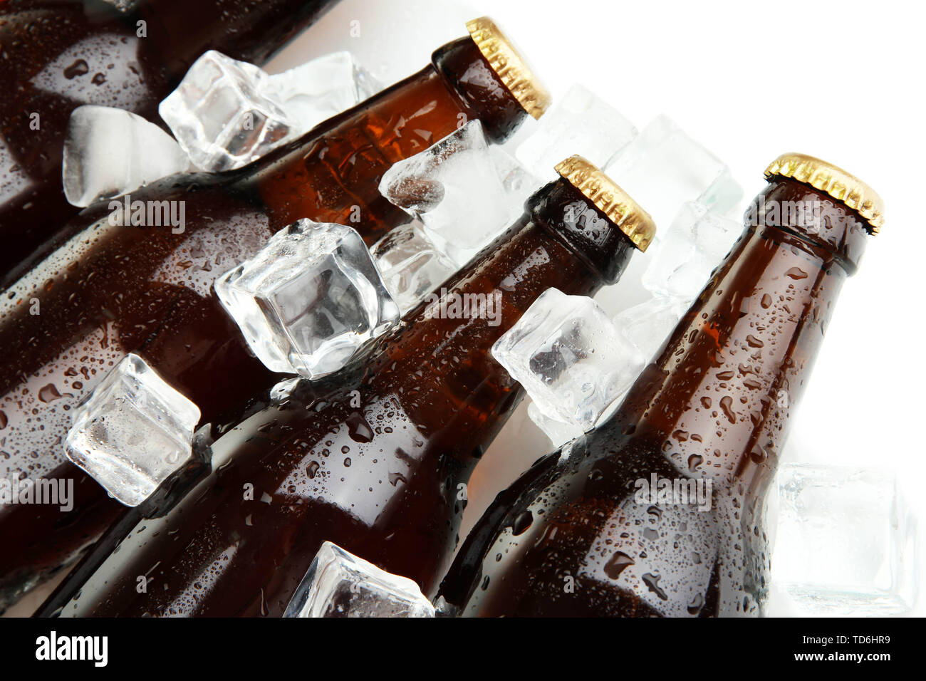 Beer bottles in ice cubes close up Stock Photo - Alamy