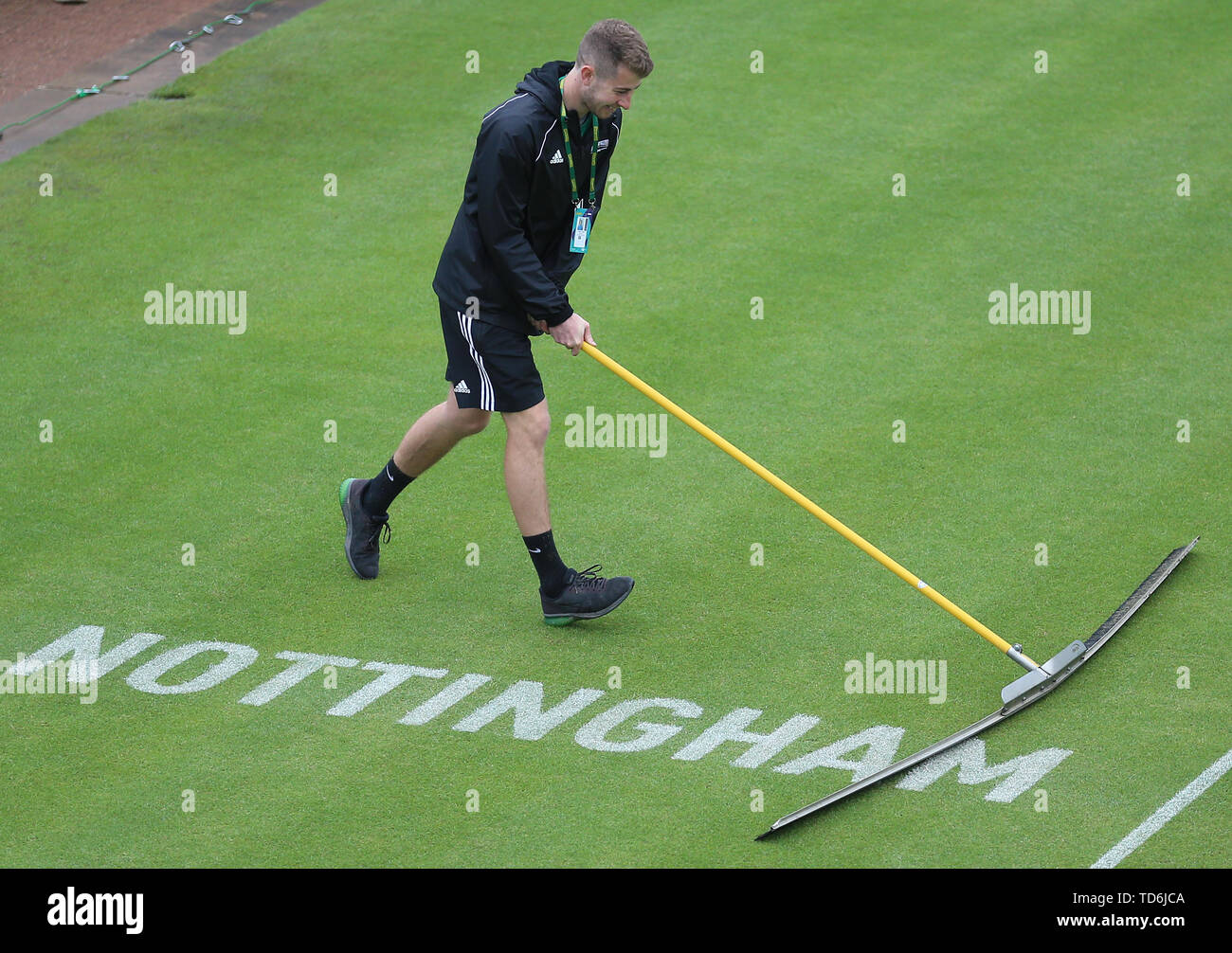 Ground staff sweep the court during day five of the Nature Valley Open ...