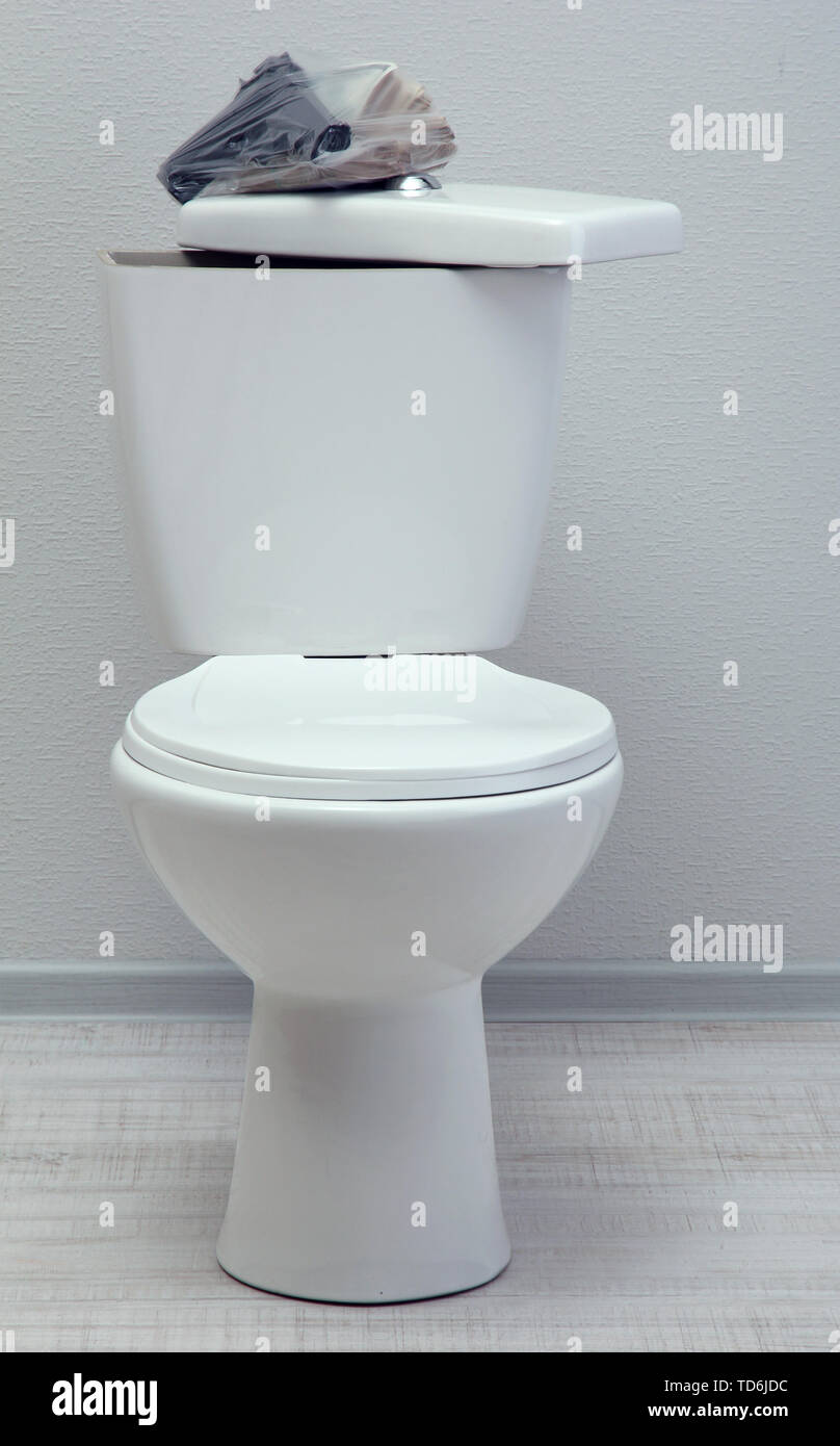 Money and gun on toilet tank in a bathroom Stock Photo - Alamy