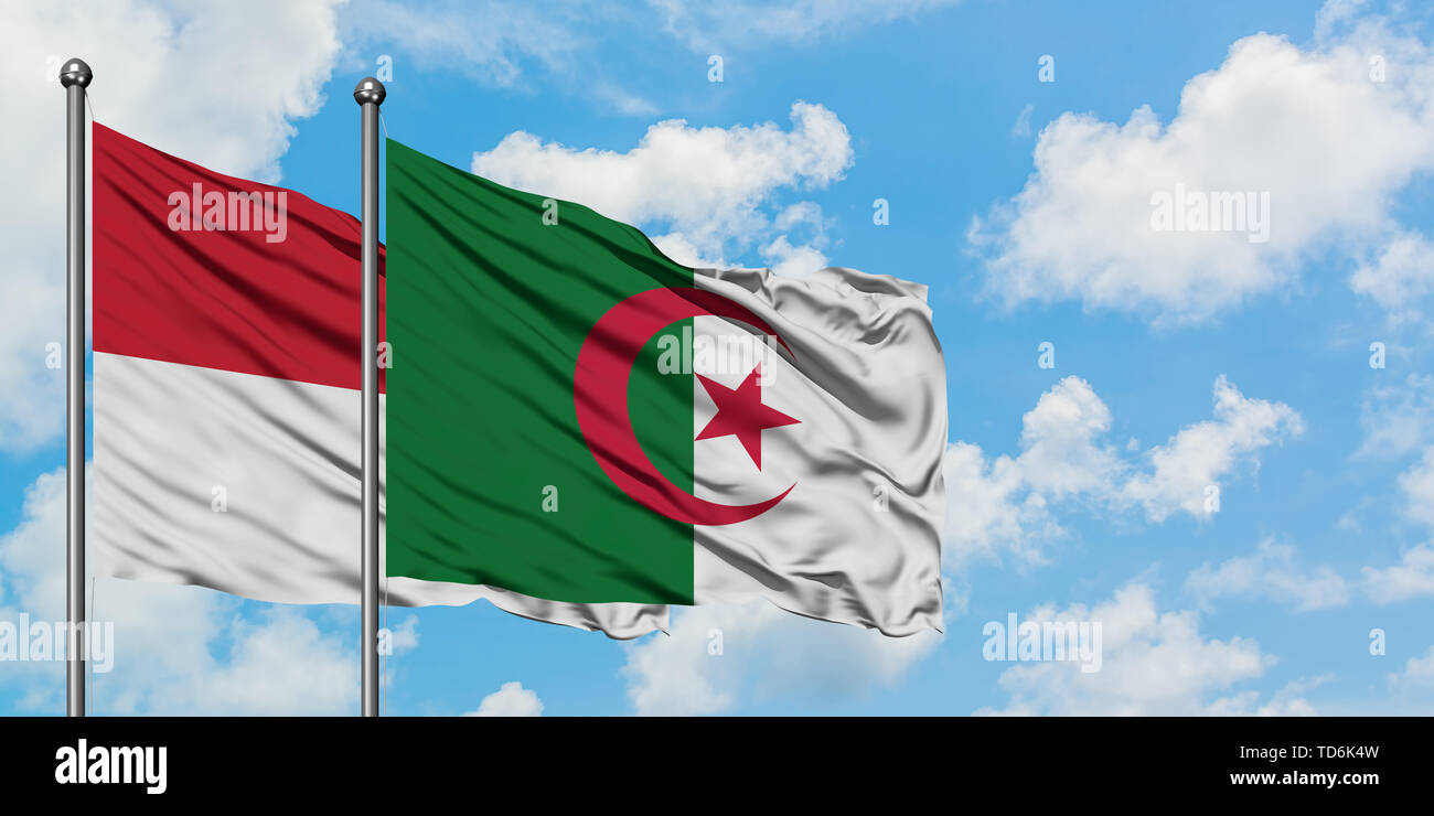 Iraq and Algeria flag waving in the wind against white cloudy blue sky ...