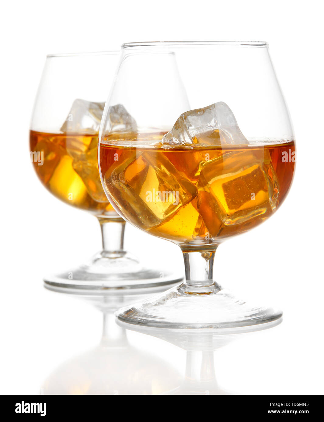 Brandy glasses with ice isolated on white Stock Photo - Alamy