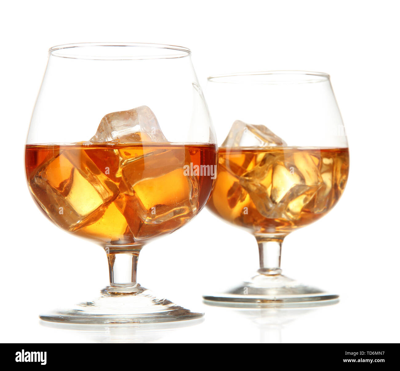 Brandy glasses with ice isolated on white Stock Photo - Alamy