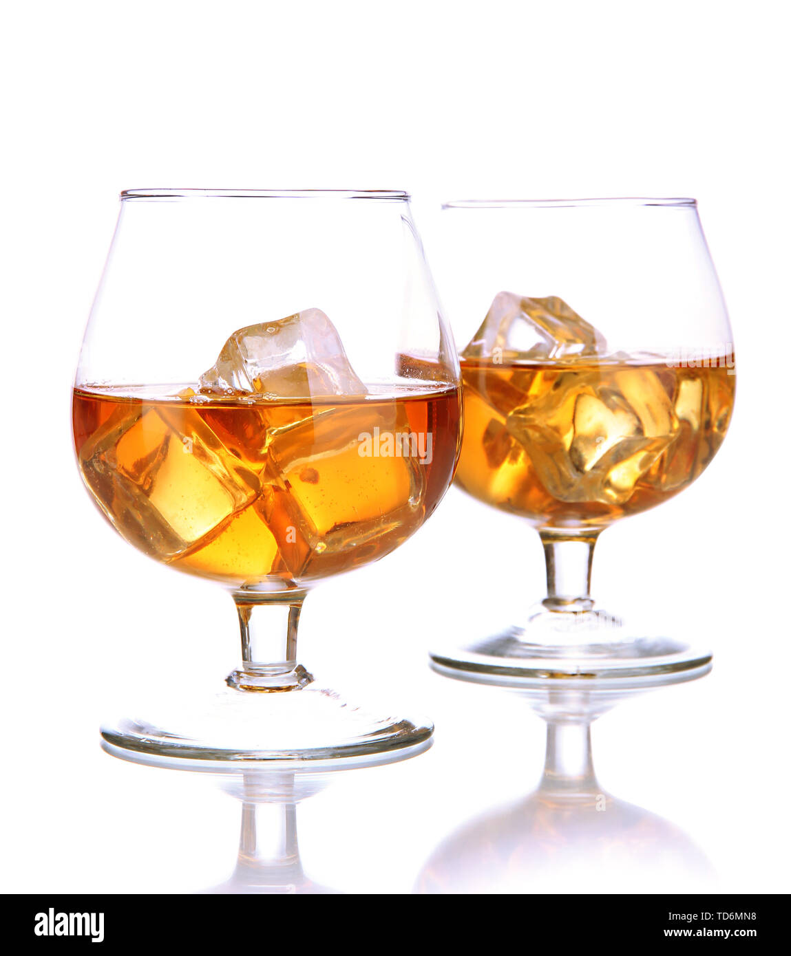 Brandy glasses with ice isolated on white Stock Photo - Alamy