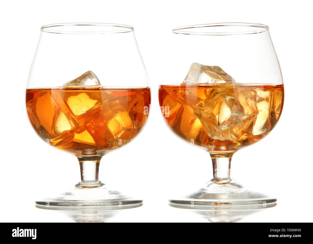 Brandy glasses with ice isolated on white Stock Photo - Alamy