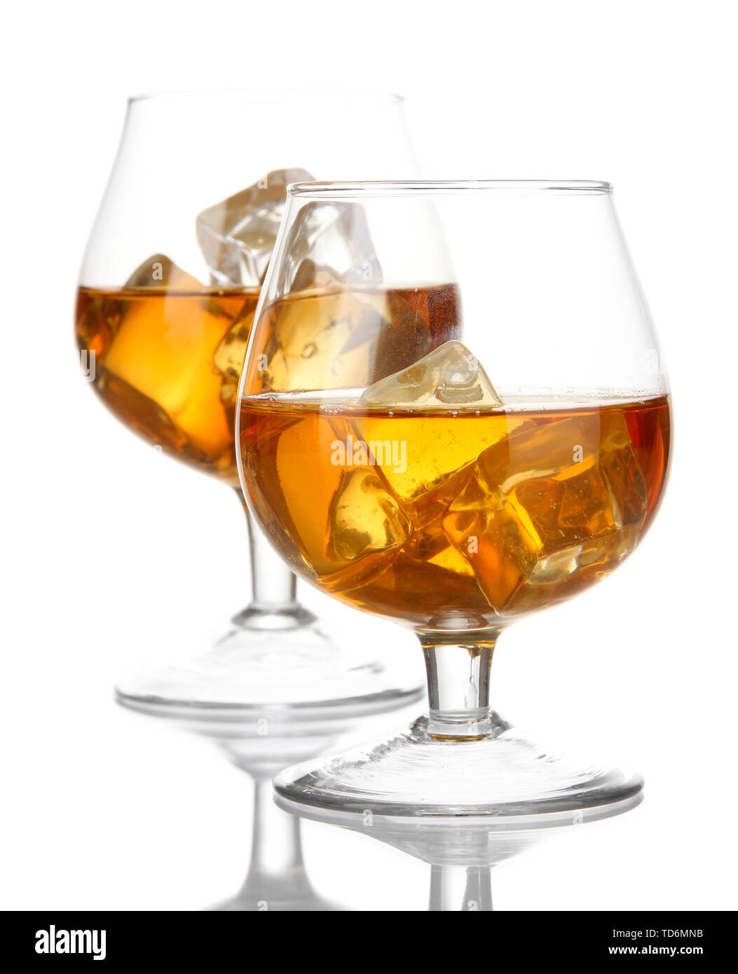 Brandy glasses with ice isolated on white Stock Photo - Alamy
