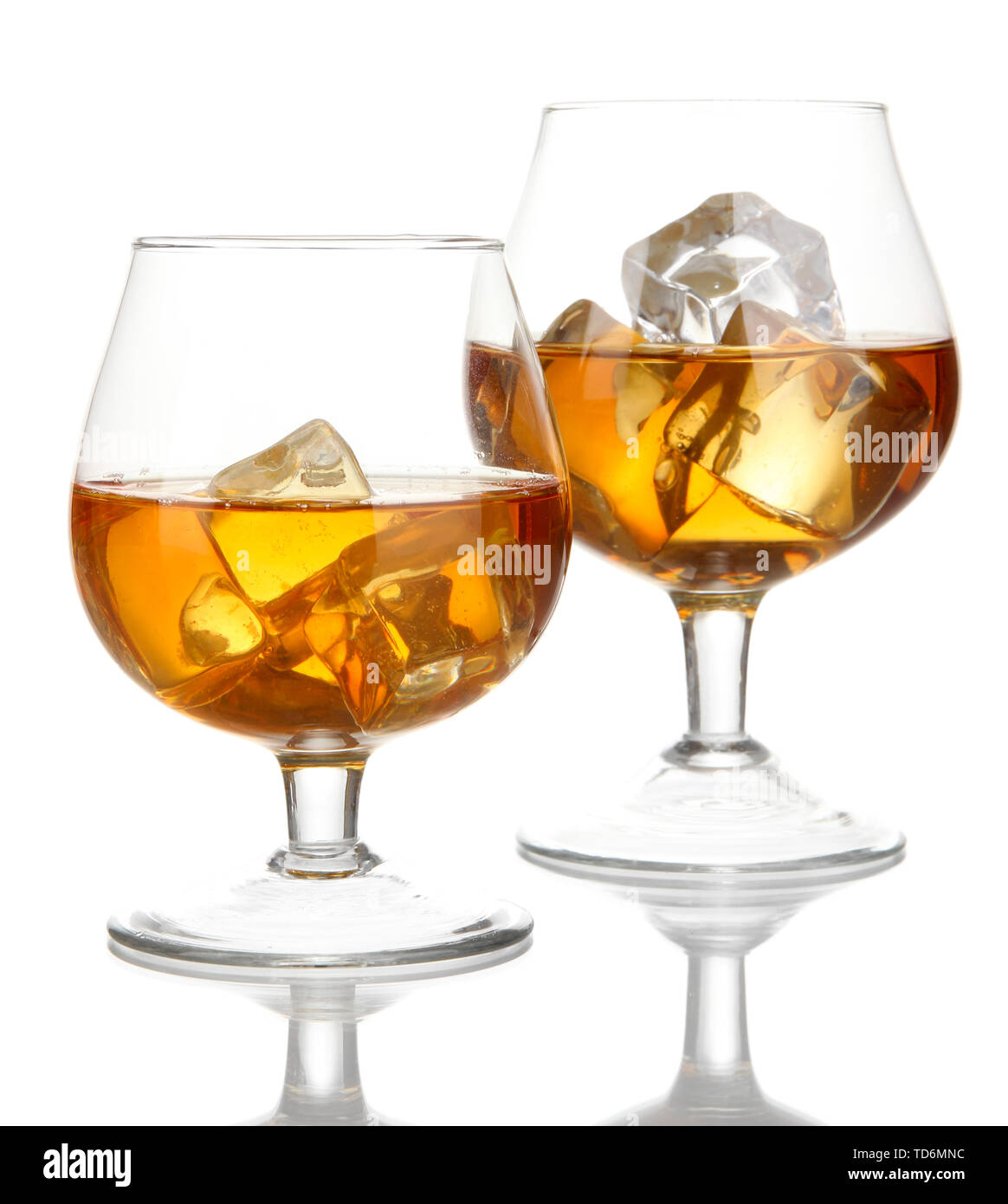 Brandy glasses with ice isolated on white Stock Photo - Alamy