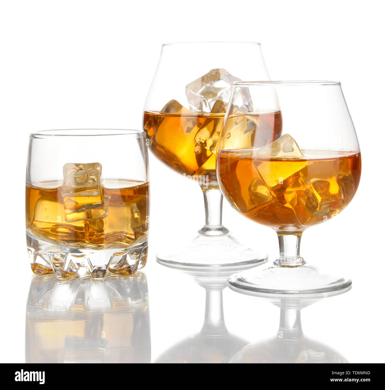 Brandy glasses with ice isolated on white Stock Photo - Alamy