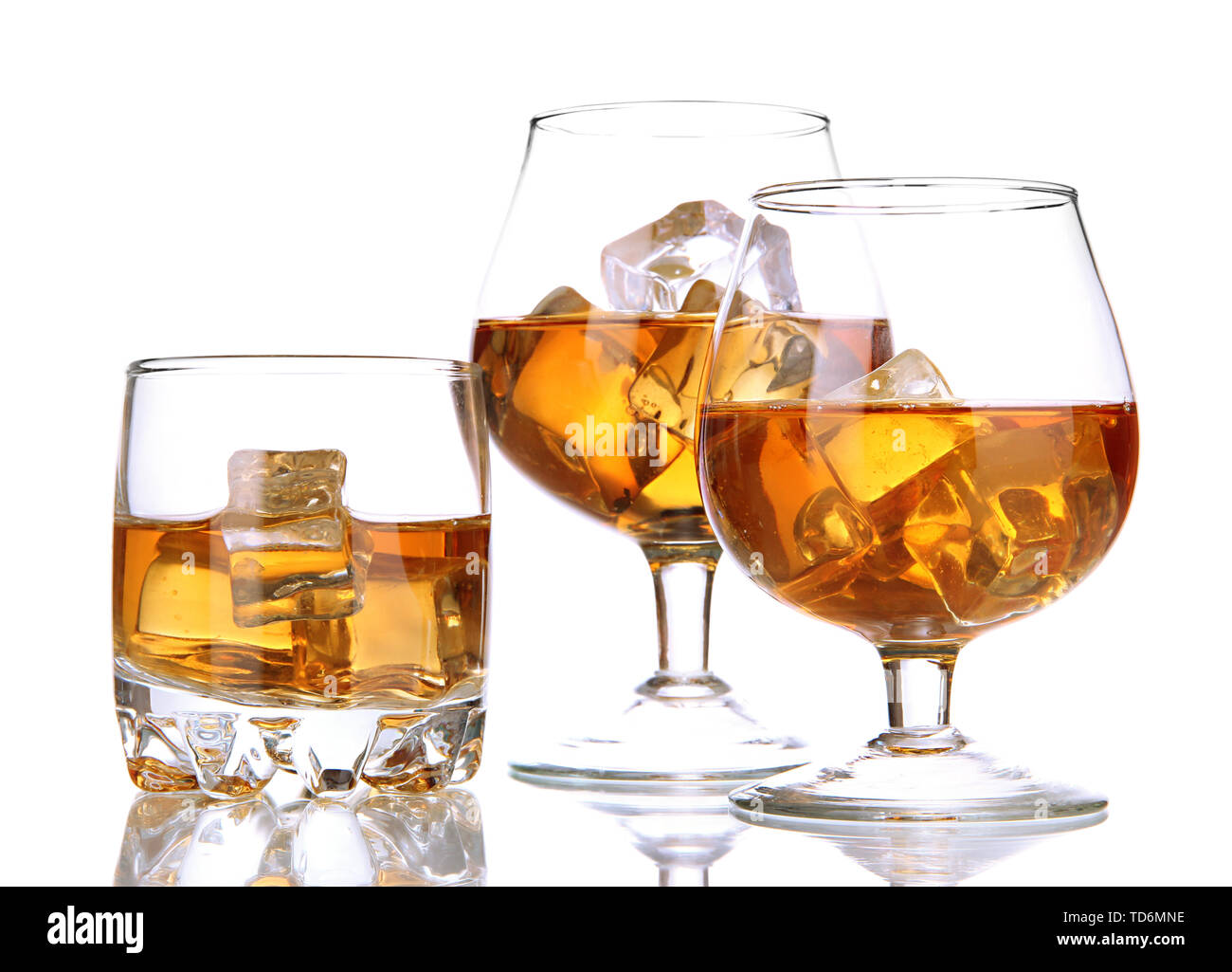 Brandy glasses with ice isolated on white Stock Photo - Alamy