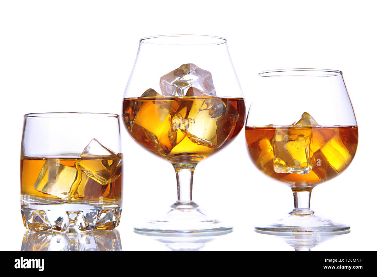 Brandy glasses with ice isolated on white Stock Photo - Alamy