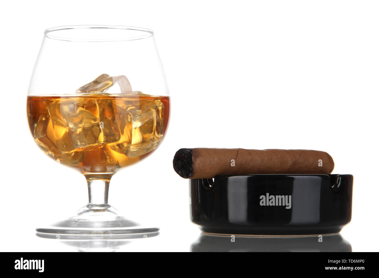 Brandy glass with ice and cigar isolated on white Stock Photo - Alamy