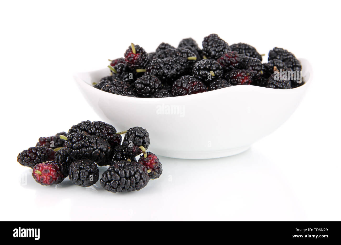 Ripe mulberries in bowl isolated on white Stock Photo - Alamy