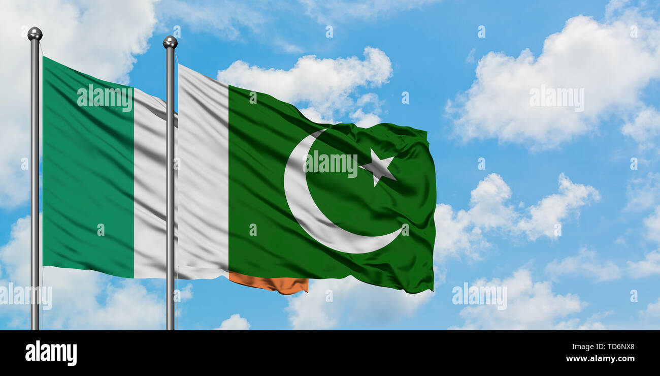 Ireland and Pakistan flag waving in the wind against white cloudy blue ...