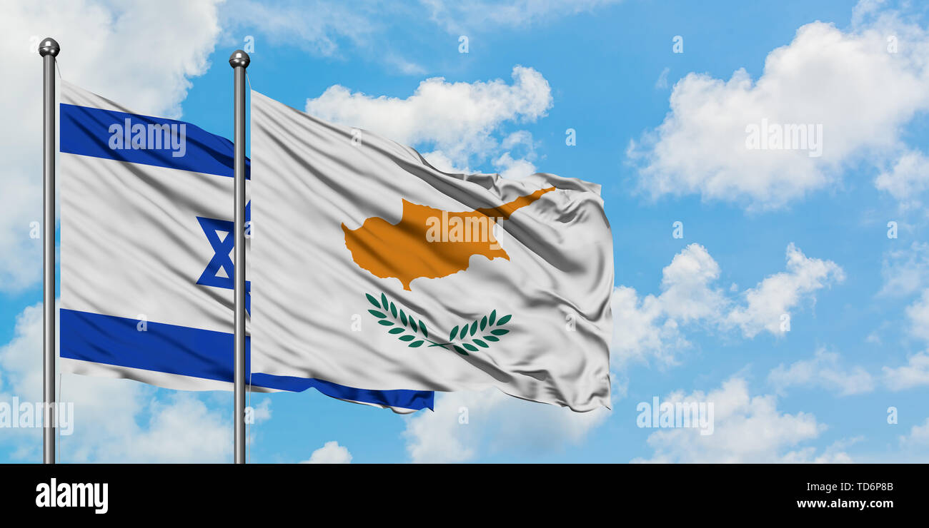 Israel and Cyprus flag waving in the wind against white cloudy blue sky ...