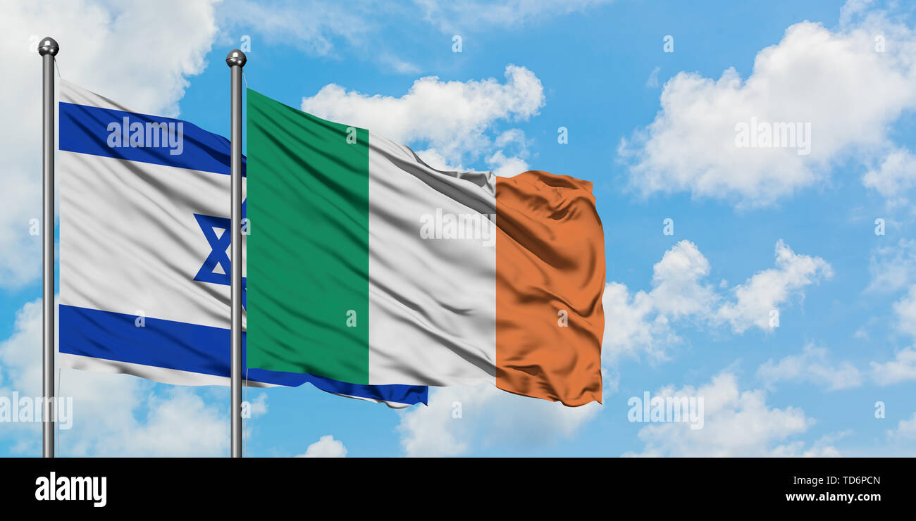 Israel and Ireland flag waving in the wind against white cloudy blue ...