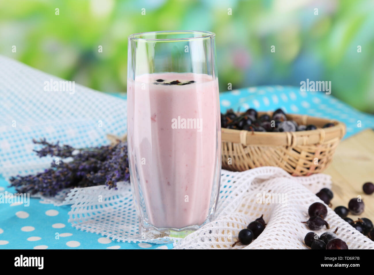 Delicious milk shake with blackberry on wooden table on natural ...