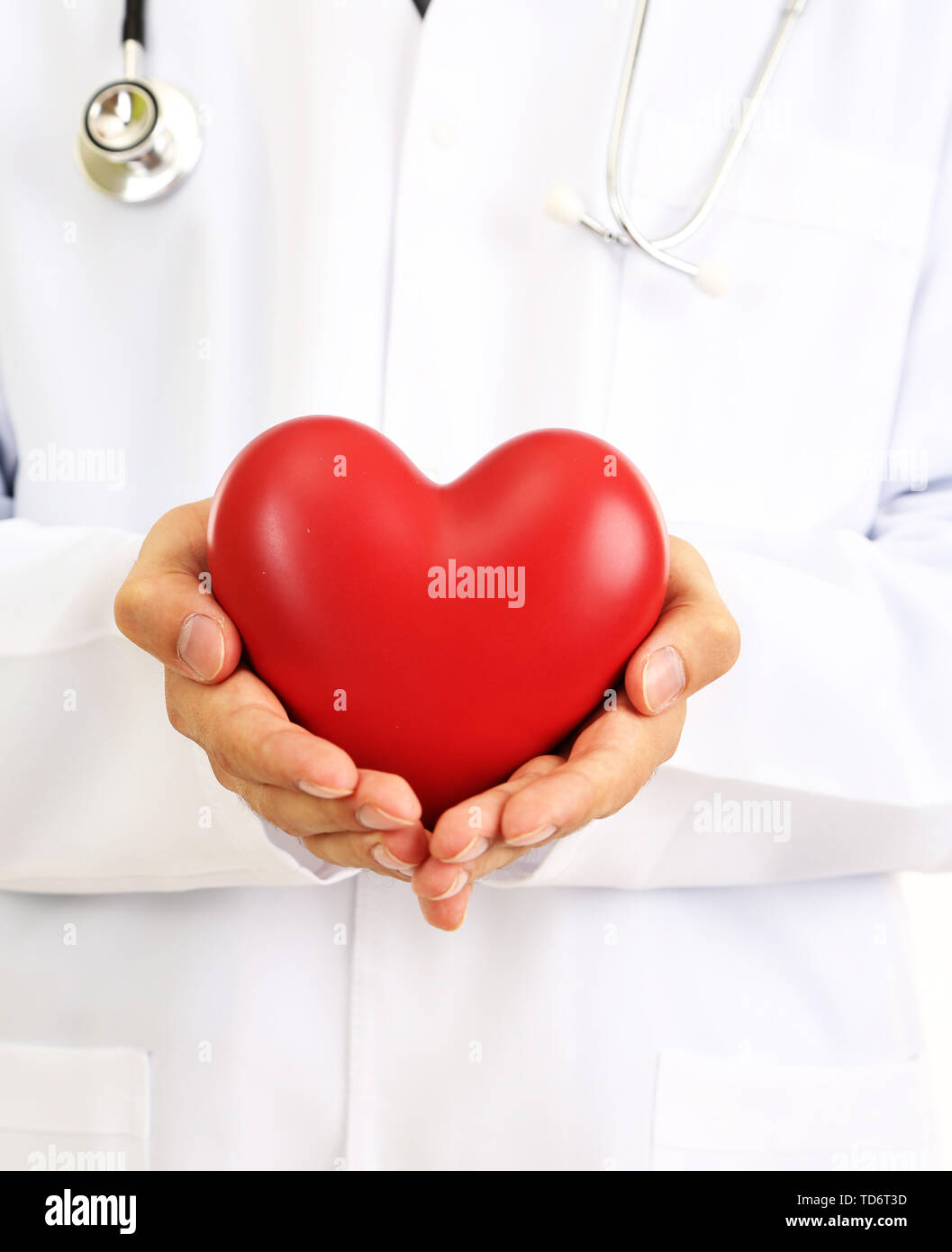 Medical doctor holding heart Stock Photo - Alamy