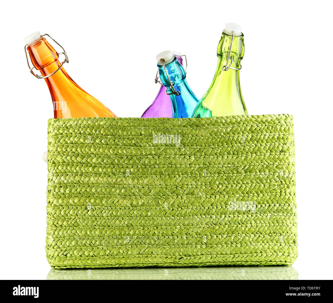 Color glass bottles in color wicker basket, isolated on white Stock ...