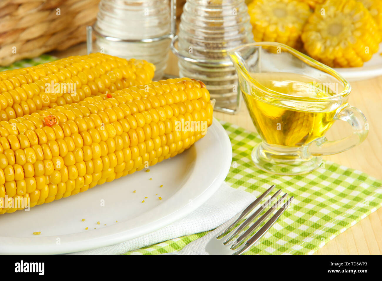 Flavored boiled corn on plate on wooden table close-up Stock Photo - Alamy