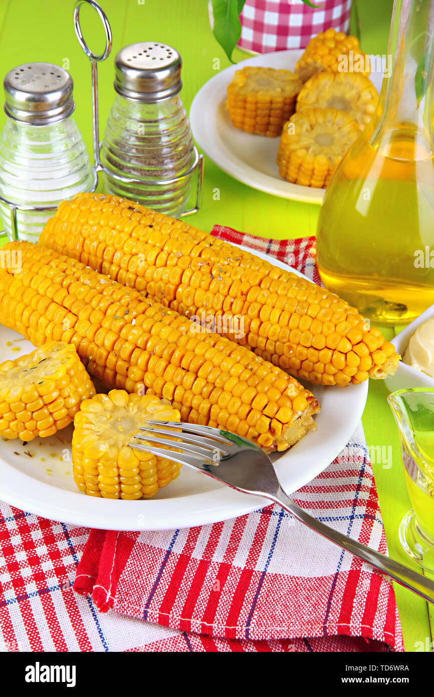 Flavored boiled corn on plate on wooden table close-up Stock Photo - Alamy