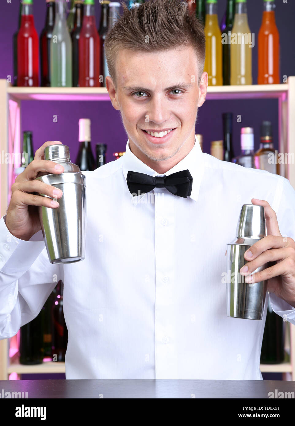 Portrait of handsome barman with two shakers, at bar Stock Photo - Alamy