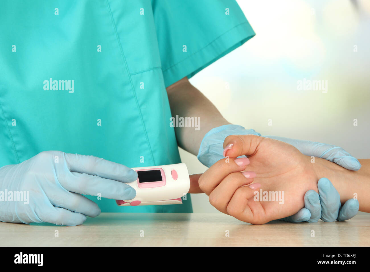 Doctor measuring pulse rate and oxygen levels, on bright background ...