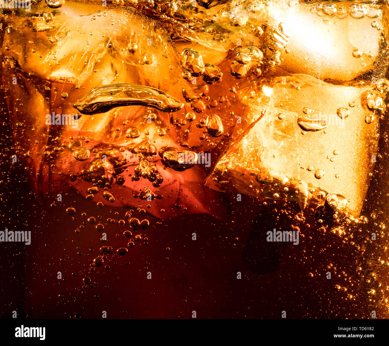 Close up view of the ice cubes in dark cola background. Texture of cooling sweet summer's drink ...