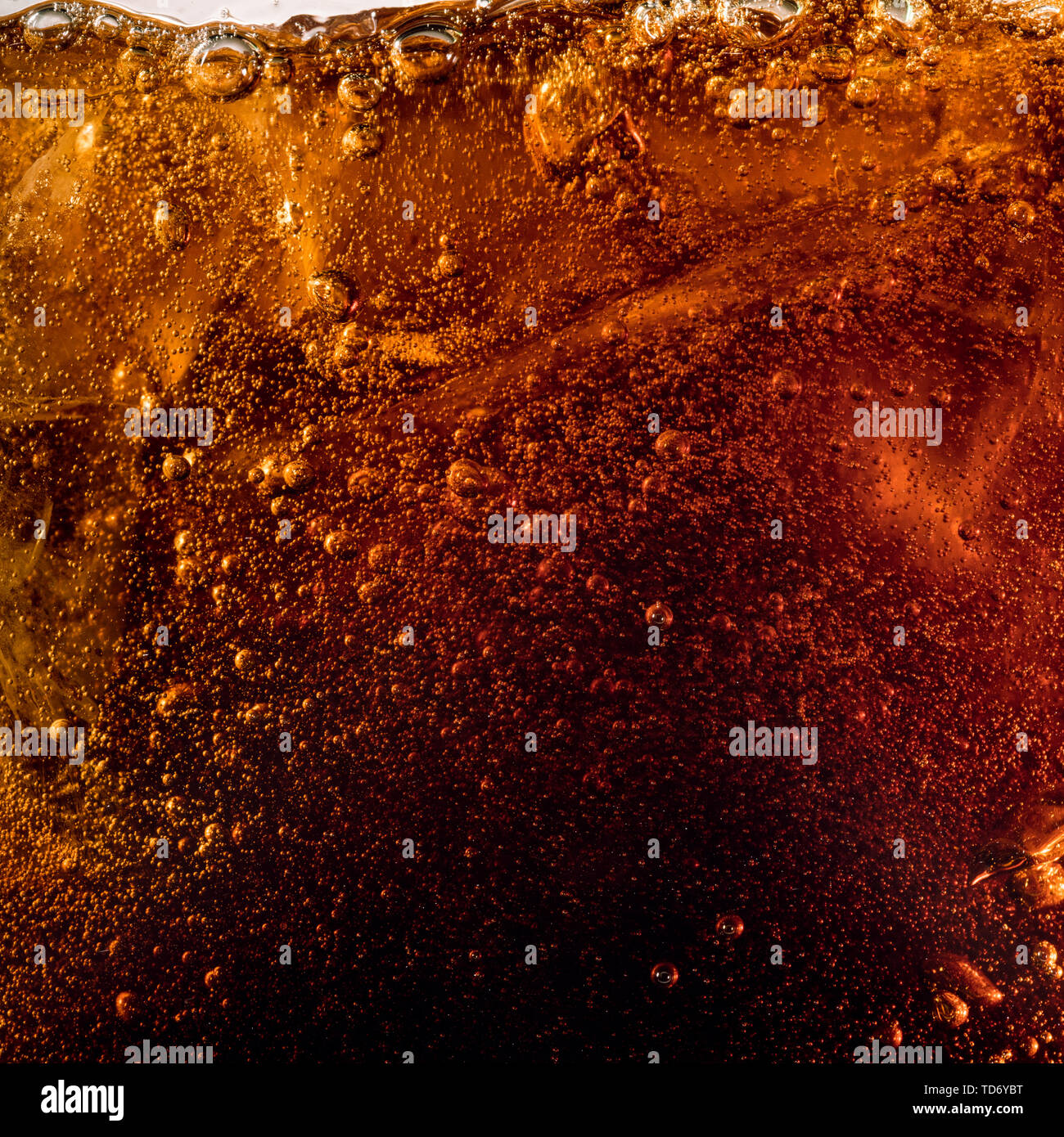 Close up view of the ice cubes in dark cola background. Texture of cooling sweet summer's drink ...