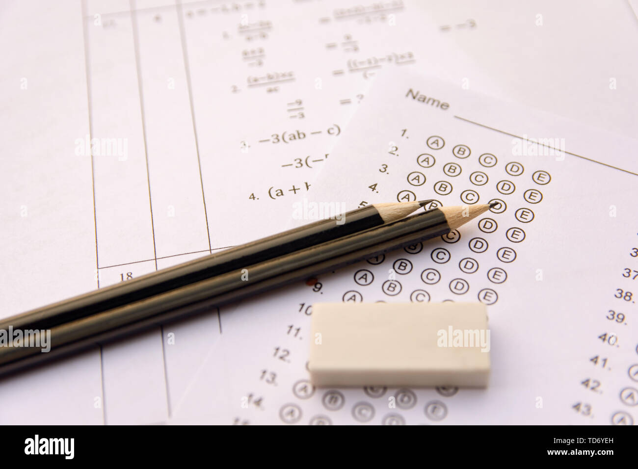 Pencil and eraser on answer sheets or Standardized test form with ...