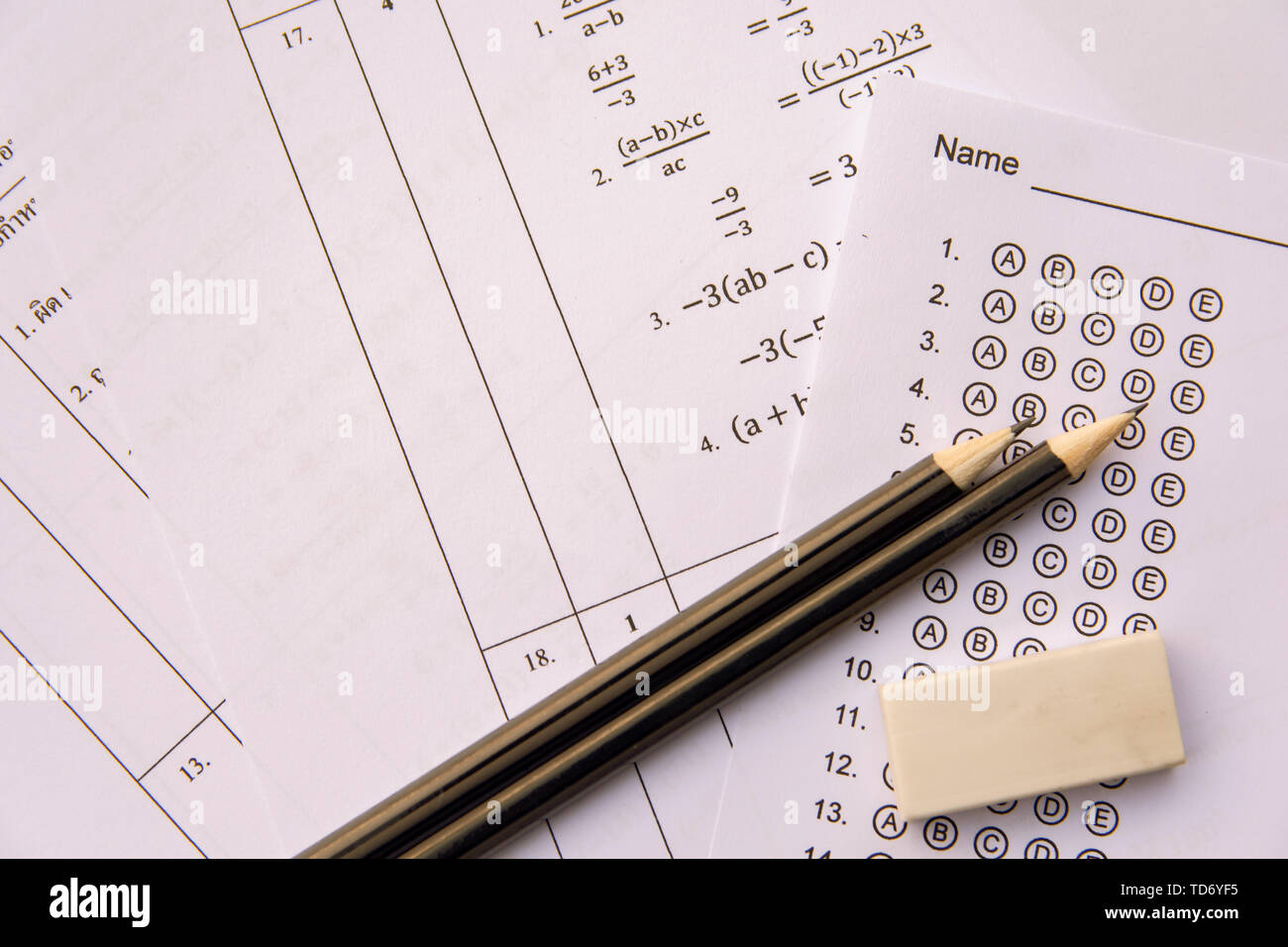 Pencil and eraser on answer sheets or Standardized test form with ...