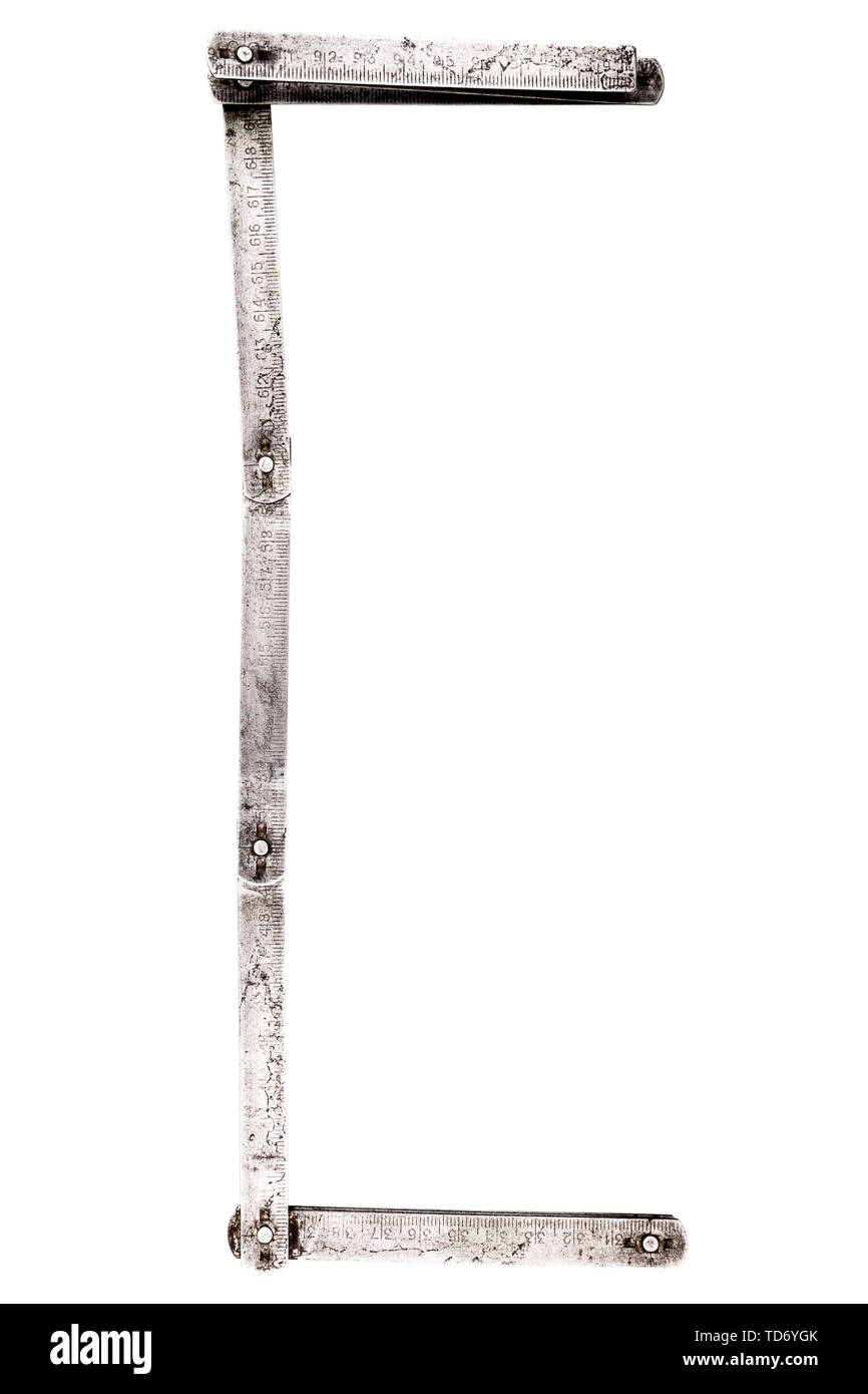 Old iron meter ruler. Old iron folding meter in the shape of letter C ...