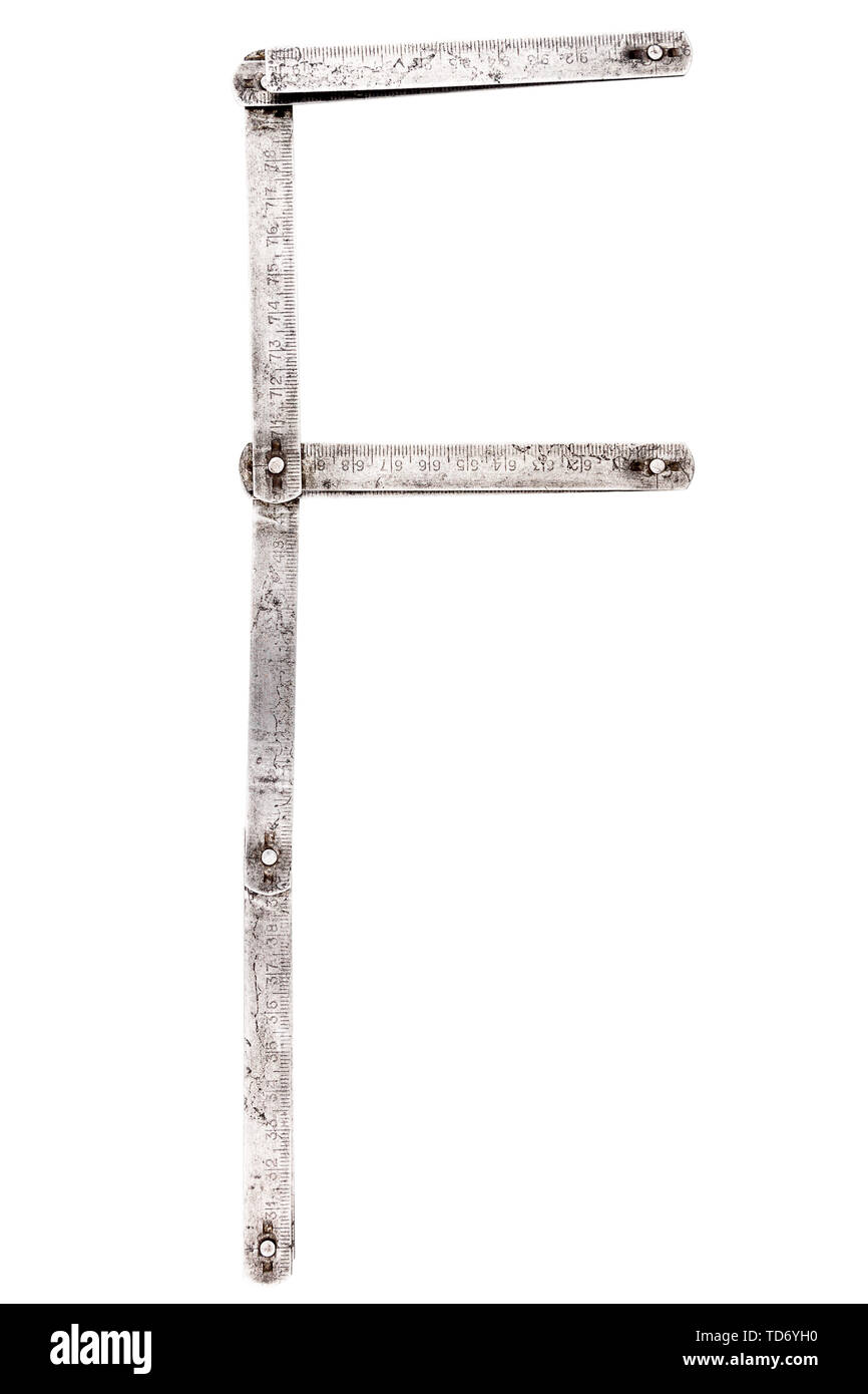 Old iron meter ruler. Old iron folding meter in the shape of letter F ...