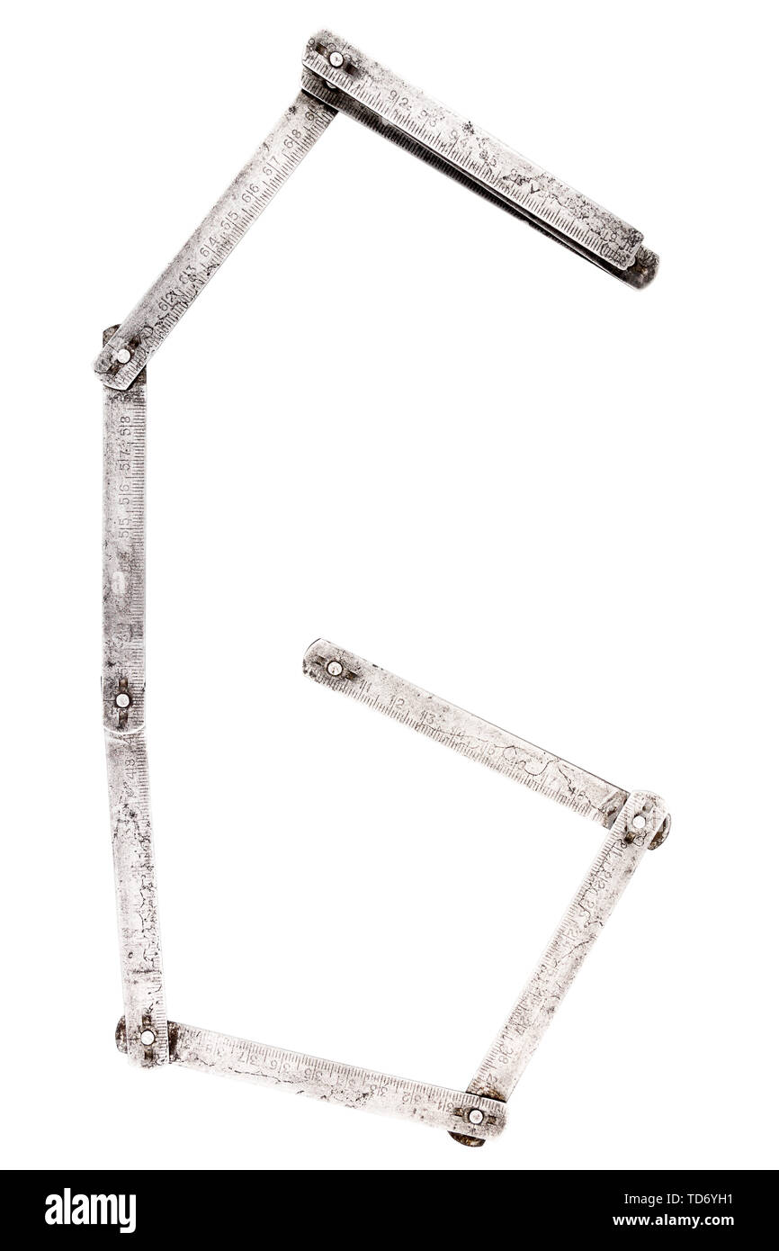 Old iron meter ruler. Old iron folding meter in the shape of letter G ...