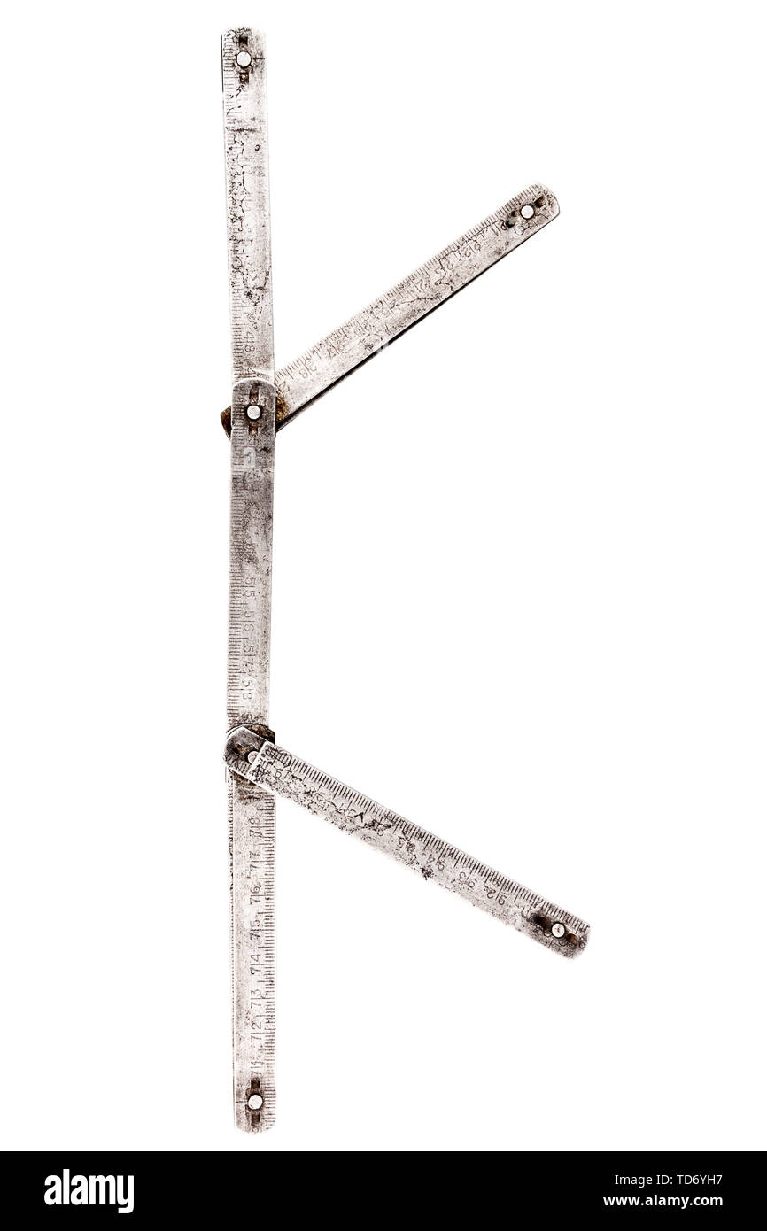 Old iron meter ruler. Old iron folding meter in the shape of letter K ...