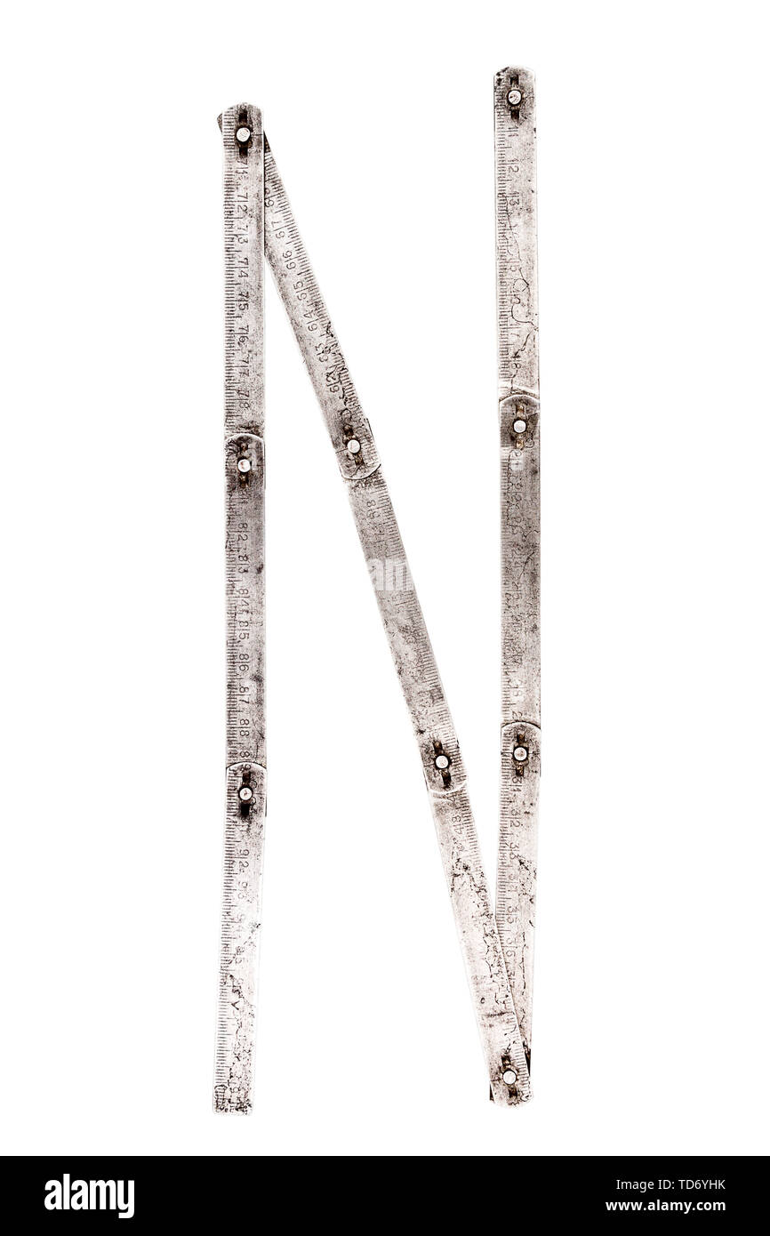 Old iron meter ruler. Old iron folding meter in the shape of letter N ...