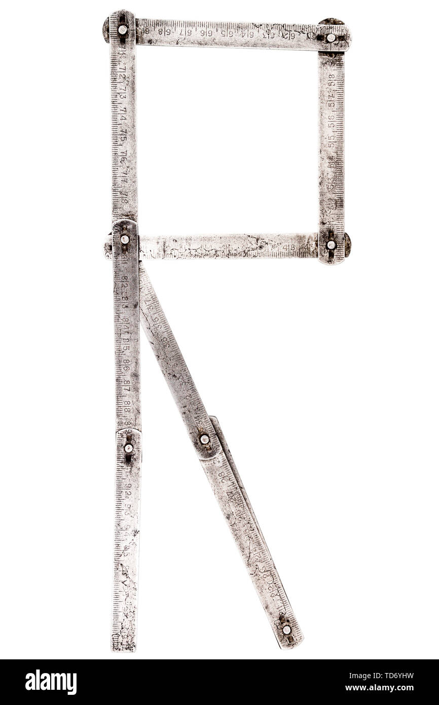 Old iron meter ruler. Old iron folding meter in the shape of letter R ...