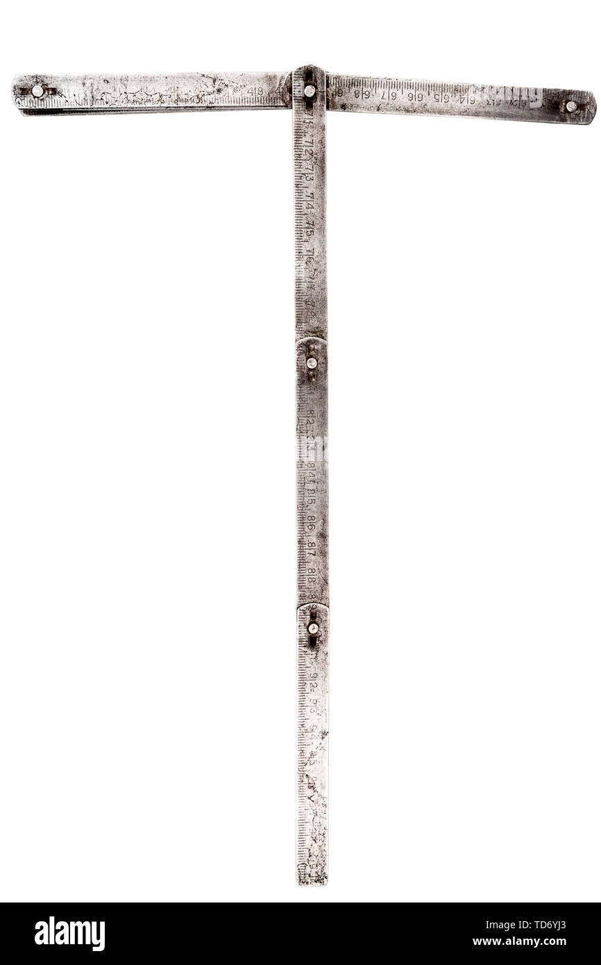 Old iron meter ruler. Old iron folding meter in the shape of letter T ...