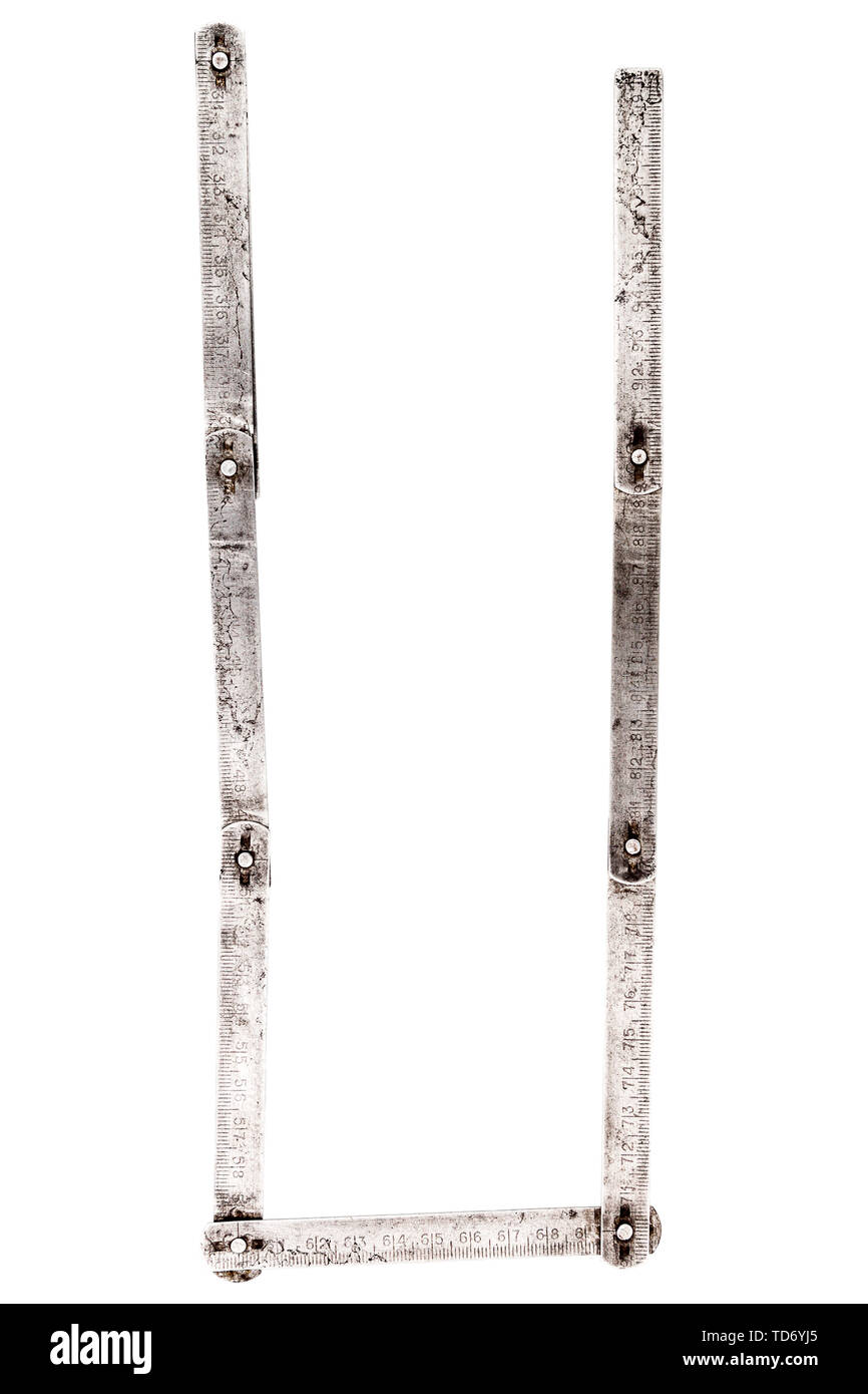 Old iron meter ruler. Old iron folding meter in the shape of letter U ...