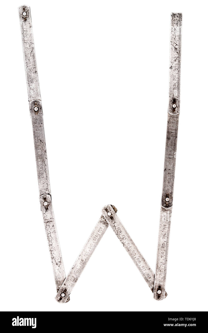 Old iron meter ruler. Old iron folding meter in the shape of letter W ...