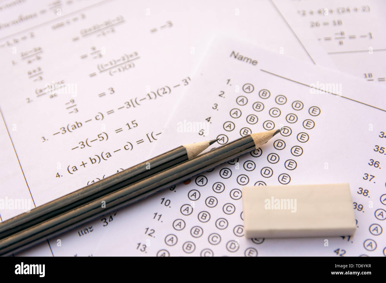 Pencil and eraser on answer sheets or Standardized test form with ...