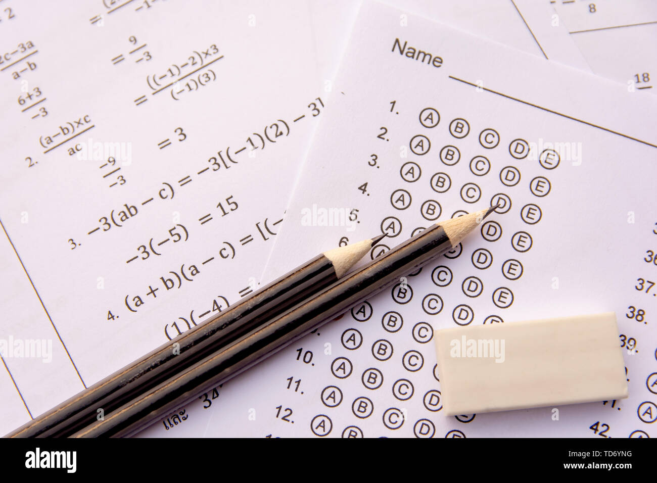 Pencil and eraser on answer sheets or Standardized test form with ...