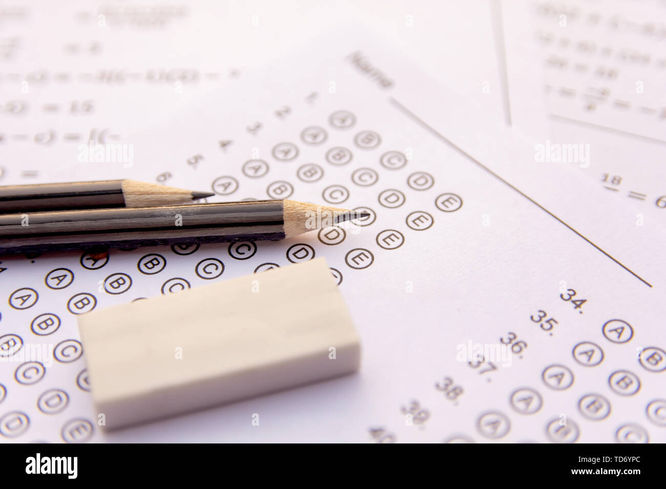 Pencil and eraser on answer sheets or Standardized test form with ...